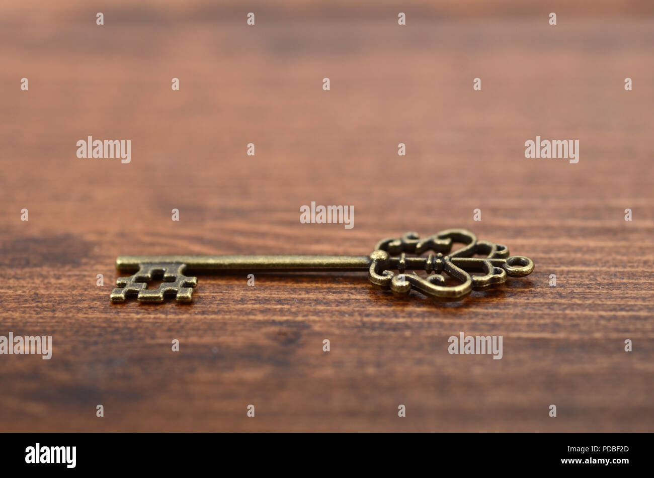 Old vintage key on a wooden background Stock Photo - Alamy