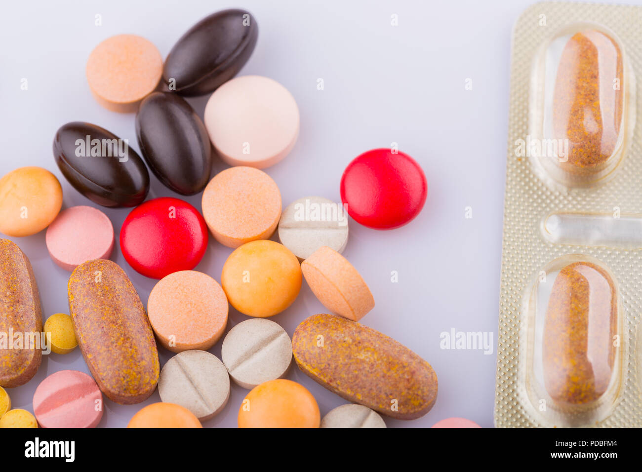 Tablets pills capsule heap mix therapy drugs, over a white background ...