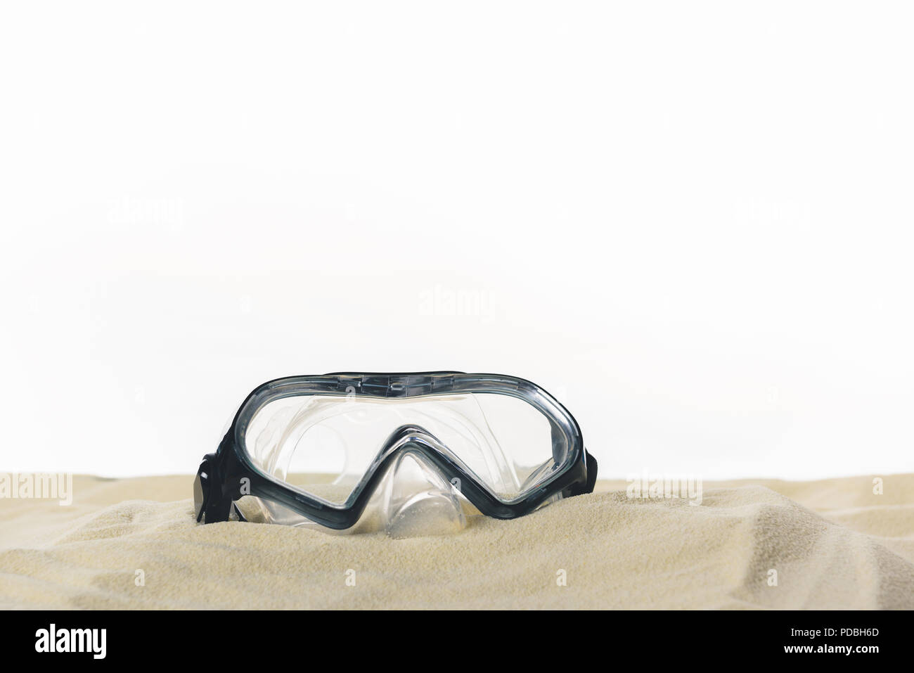 Diving mask in sand isolated on white Stock Photo - Alamy