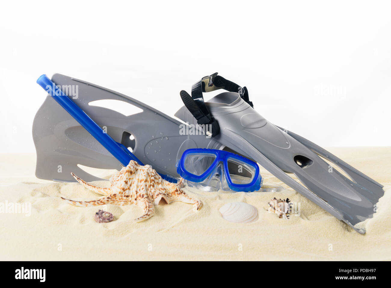 Flippers and dive mask in sand isolated on white Stock Photo - Alamy