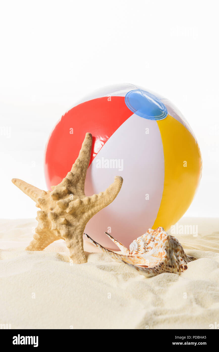Beach ball and starfish in sand isolated on white Stock Photo - Alamy