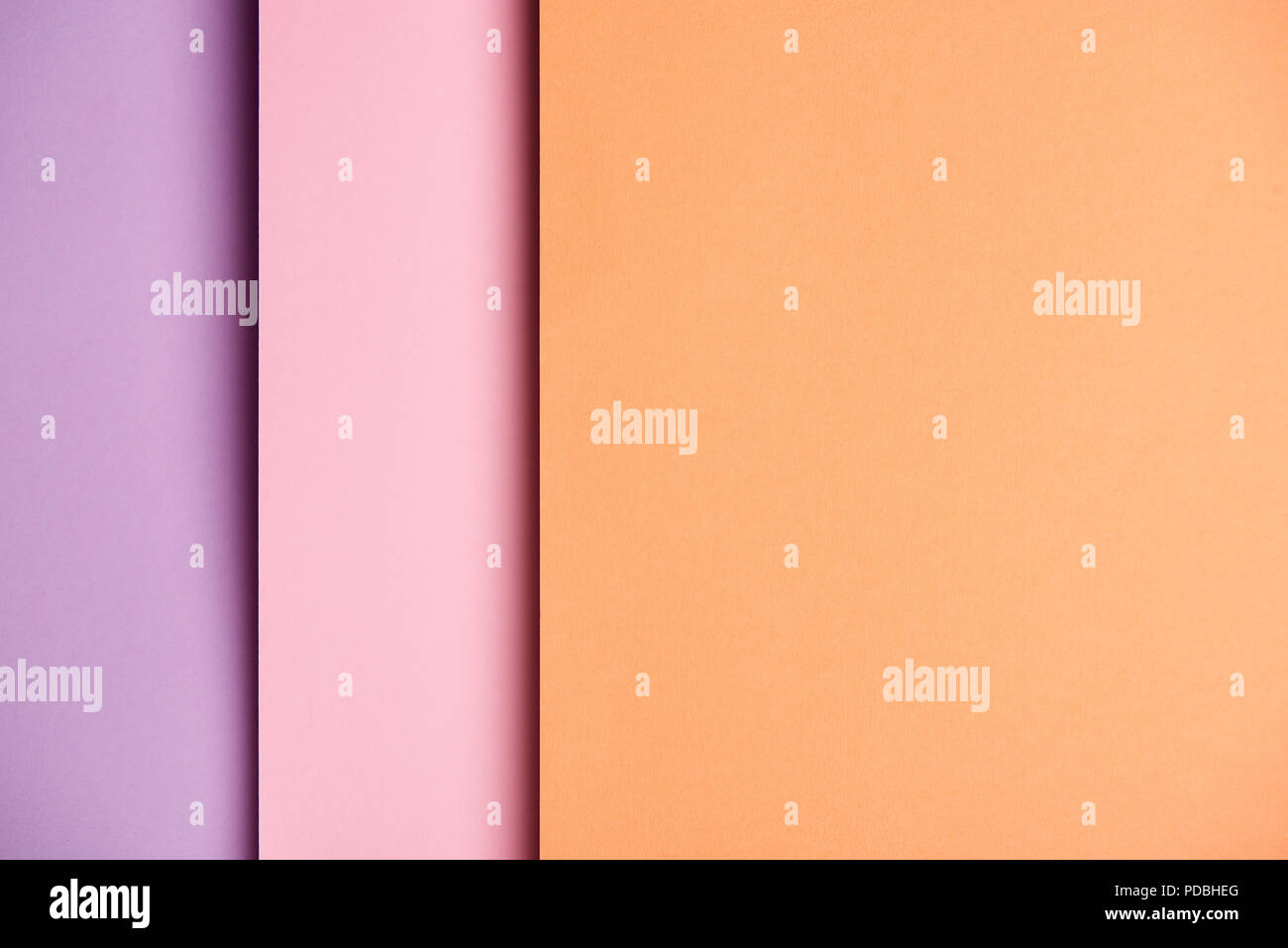 Paper sheets in pink and orange tones background Stock Photo - Alamy