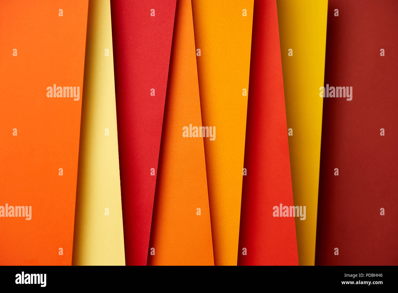 Paper sheets in warm colors background Stock Photo - Alamy