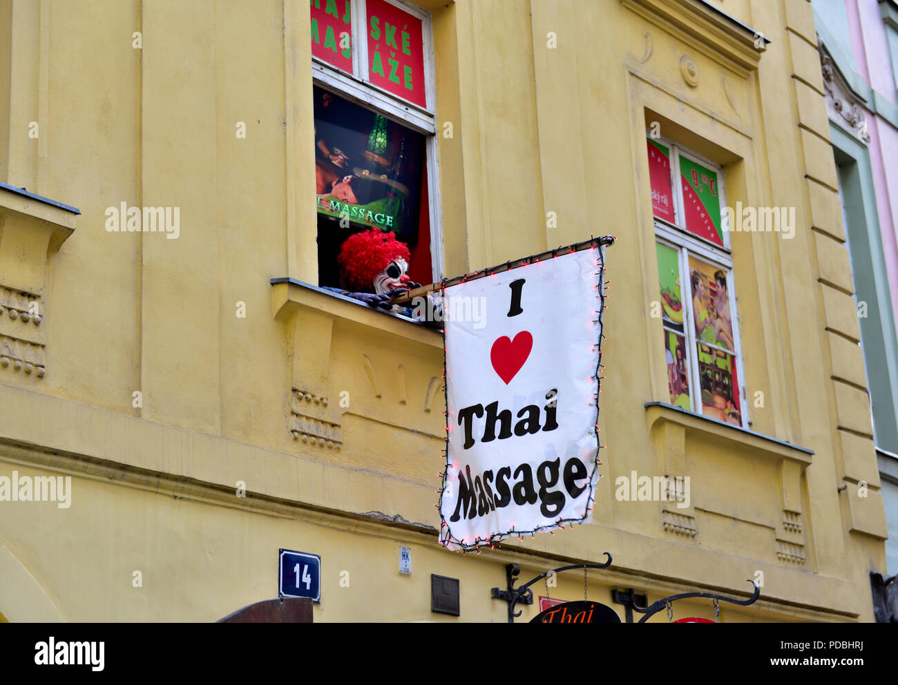 Sign hanging out of window in Prague, Czech Republic, "I love Thai Massage Stock Photo - Alamy