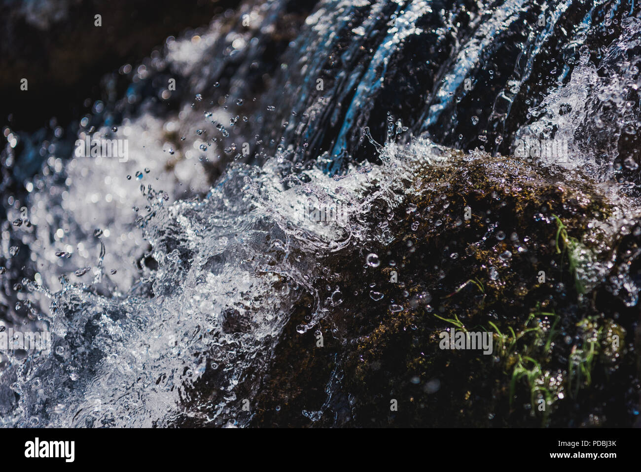 selective focus of water flowing with splashes outdoors Stock Photo - Alamy