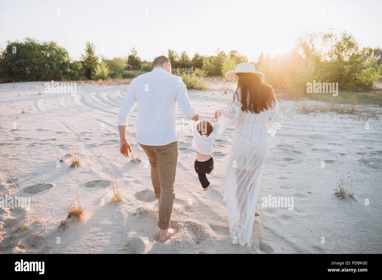 Rear view back family holding hands hi-res stock photography and images ...