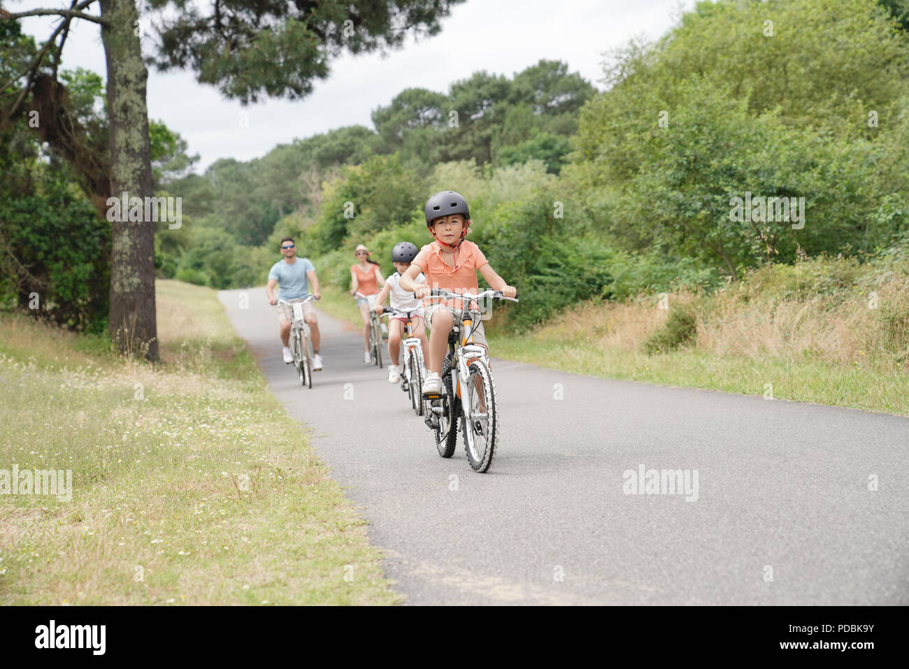 Kids adults riding bicycles hi-res stock photography and images - Alamy