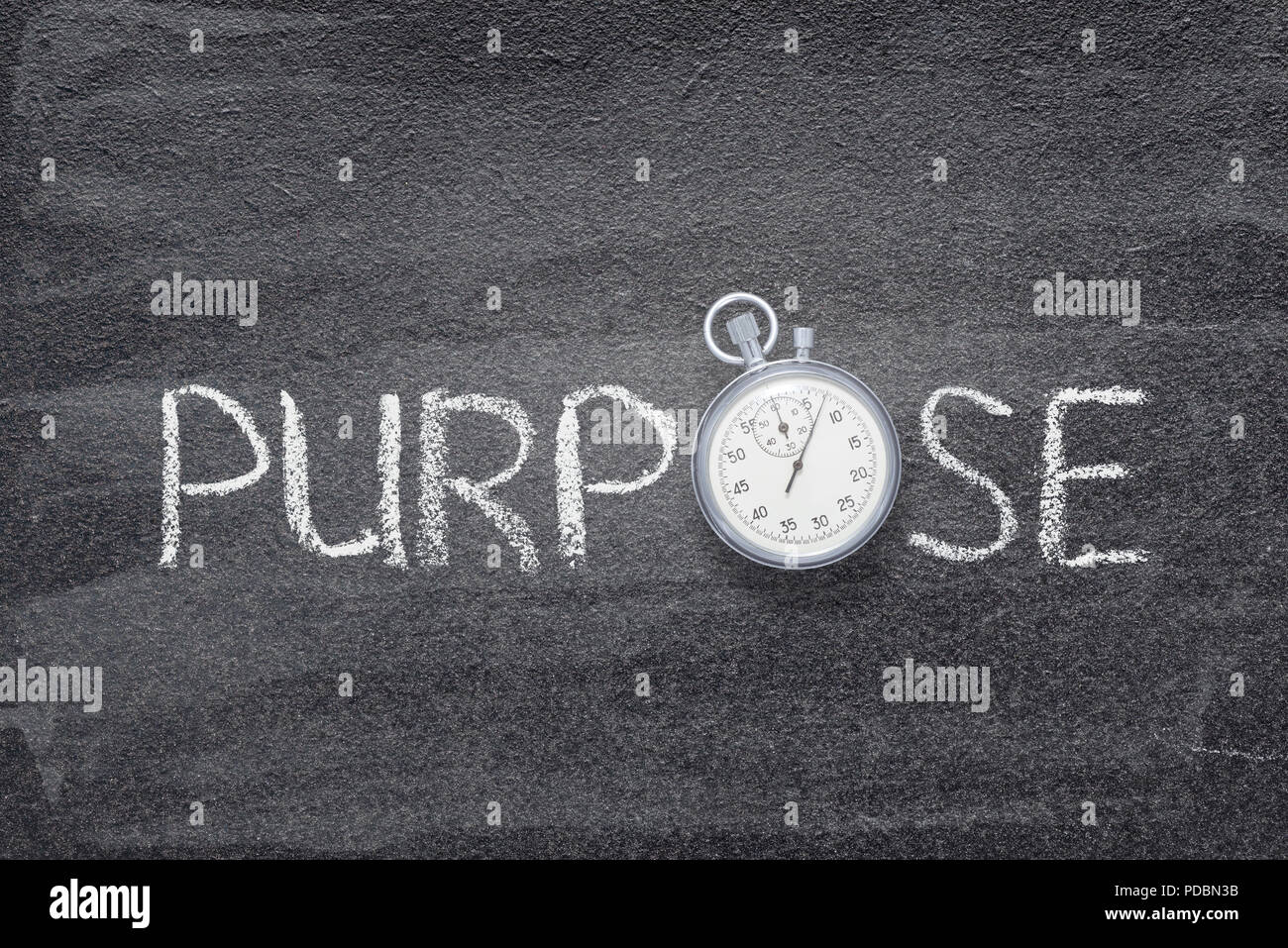 purpose word handwritten on chalkboard with vintage precise stopwatch ...