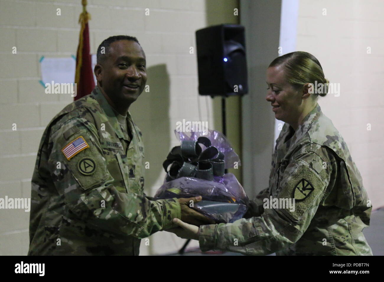 Lt. Col. Mike Navarro receives a fruit basket after his farewell speech ...