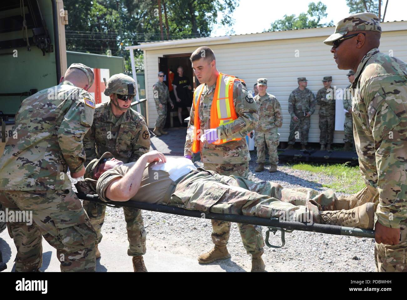 278th ACR soldiers lift a casualty patient into a field liter ambulance ...