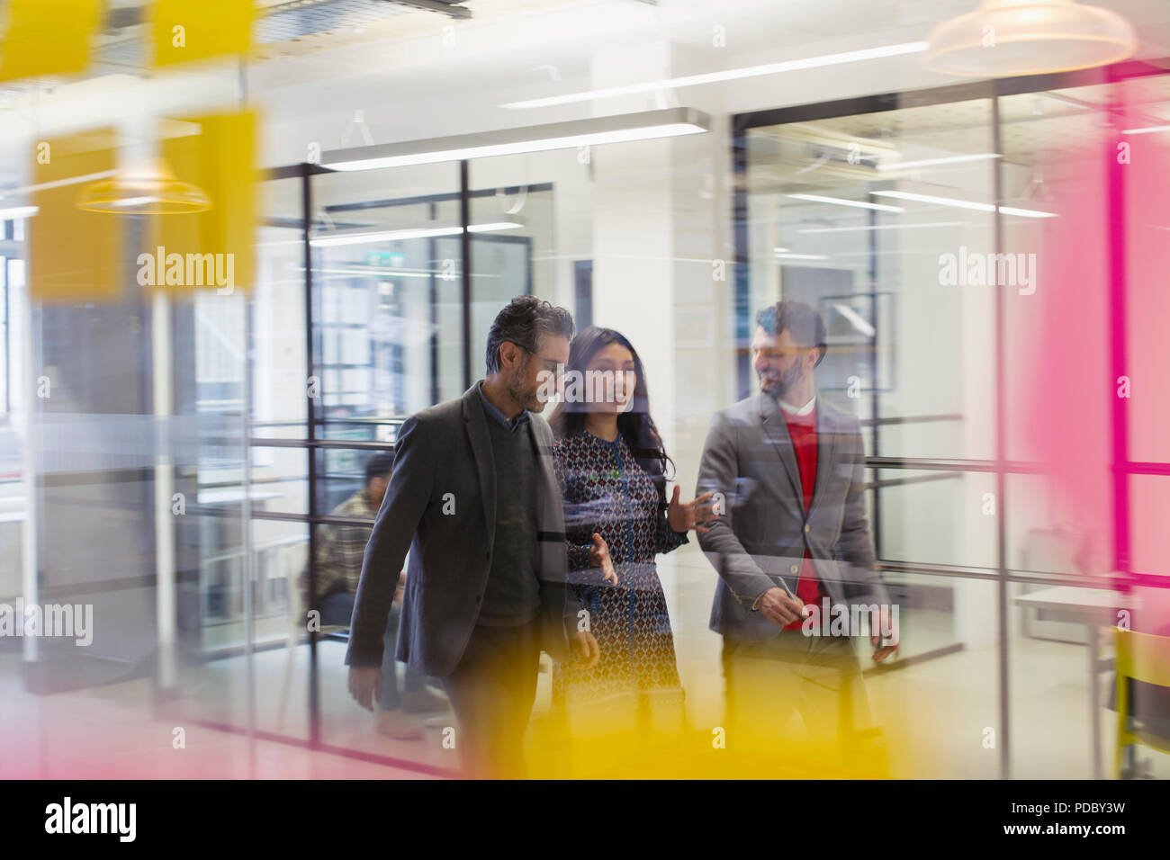 Business people walking in office Stock Photo - Alamy