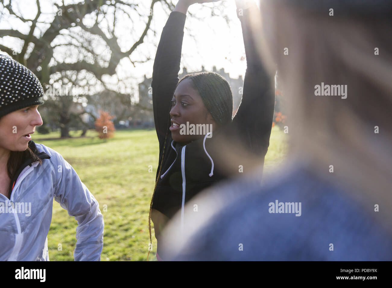 Woman runner warming up stretching hi-res stock photography and images ...