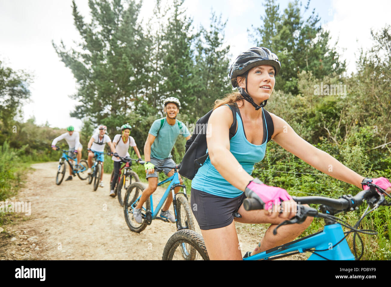 Friends mountain biking on trail Stock Photo - Alamy