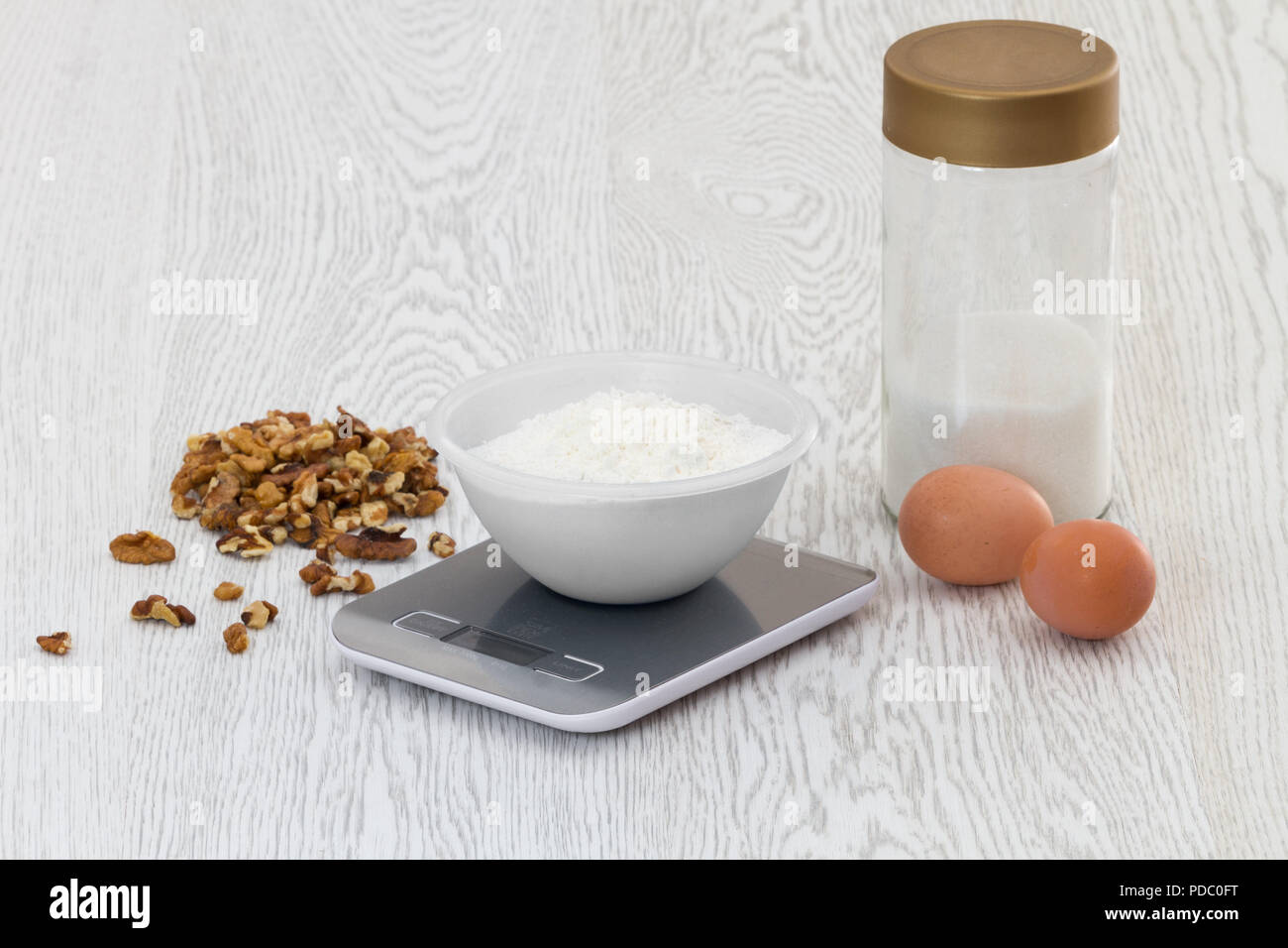 Electric Digital kitchen scale in the kitchen with cake ingredients ...
