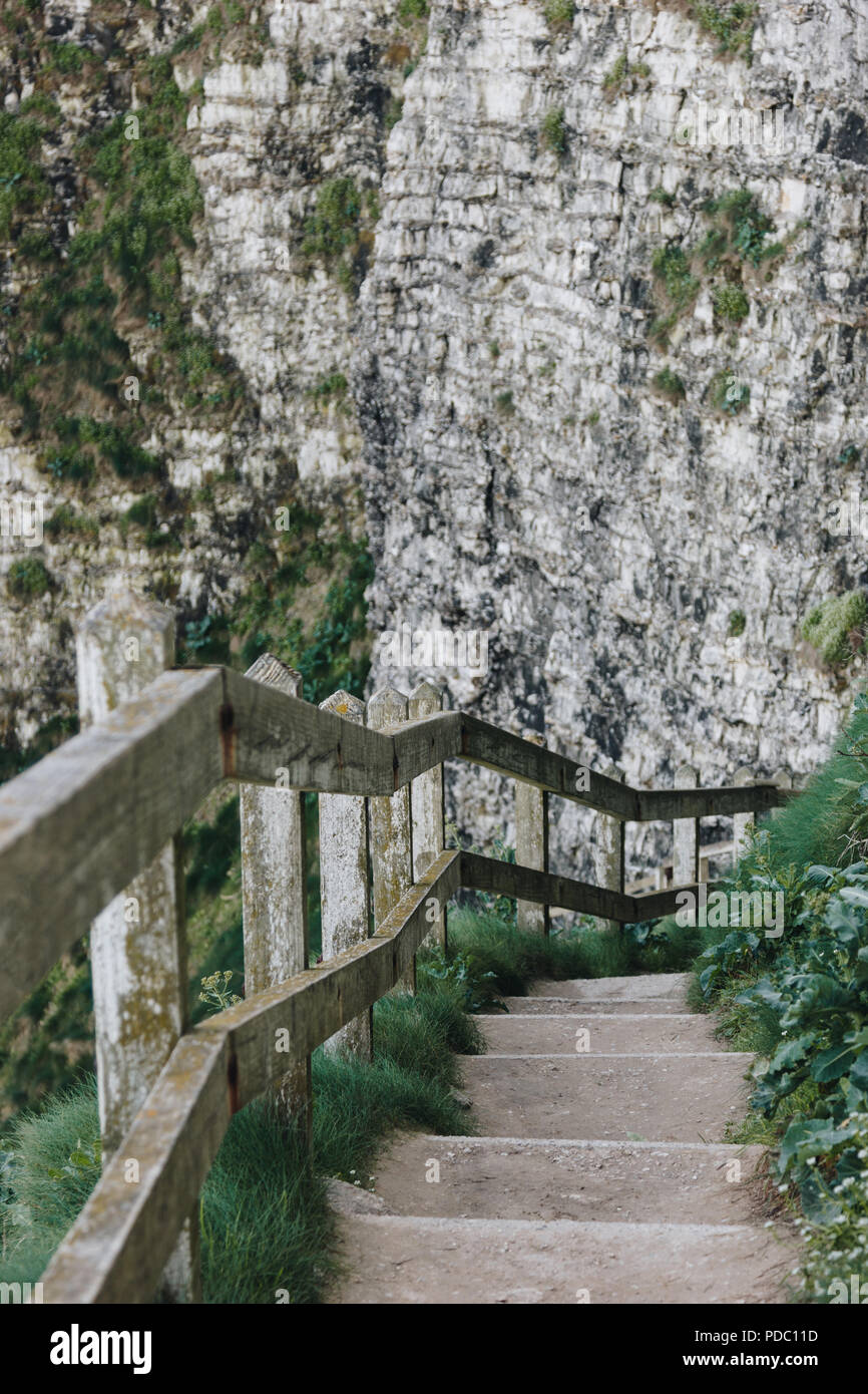 stone stairs with wooden railing on cliff, Etretat, Normandy, France ...