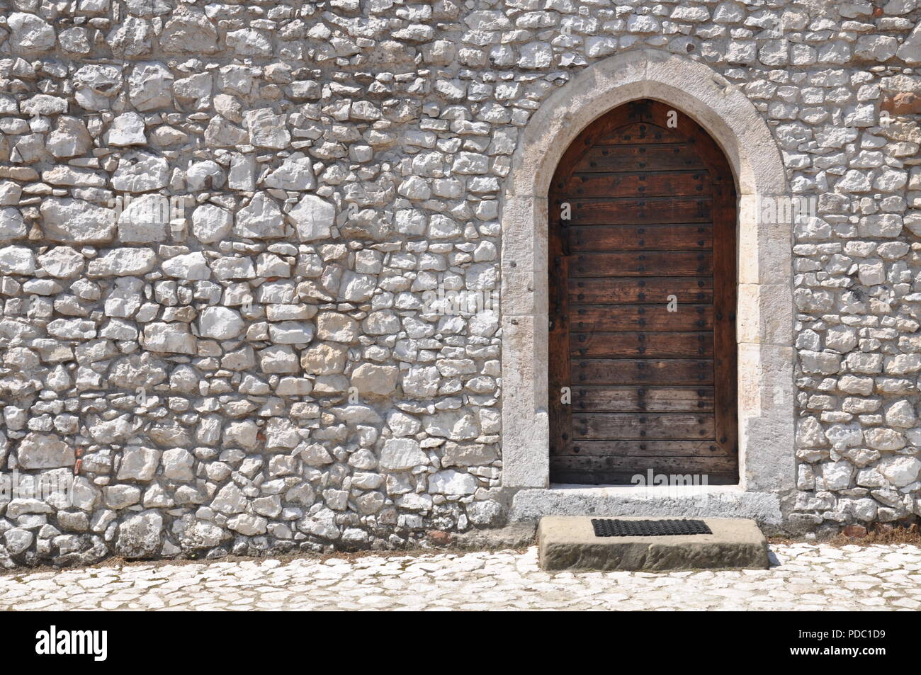 Ancient wooden door and stone wall Stock Photo - Alamy