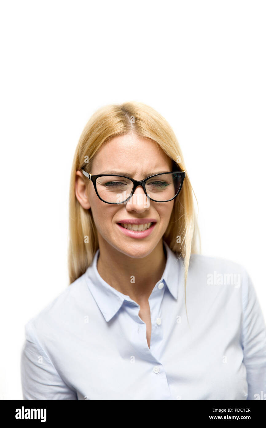 Studio portrait of young businesswoman with eyeglasses under stress ...