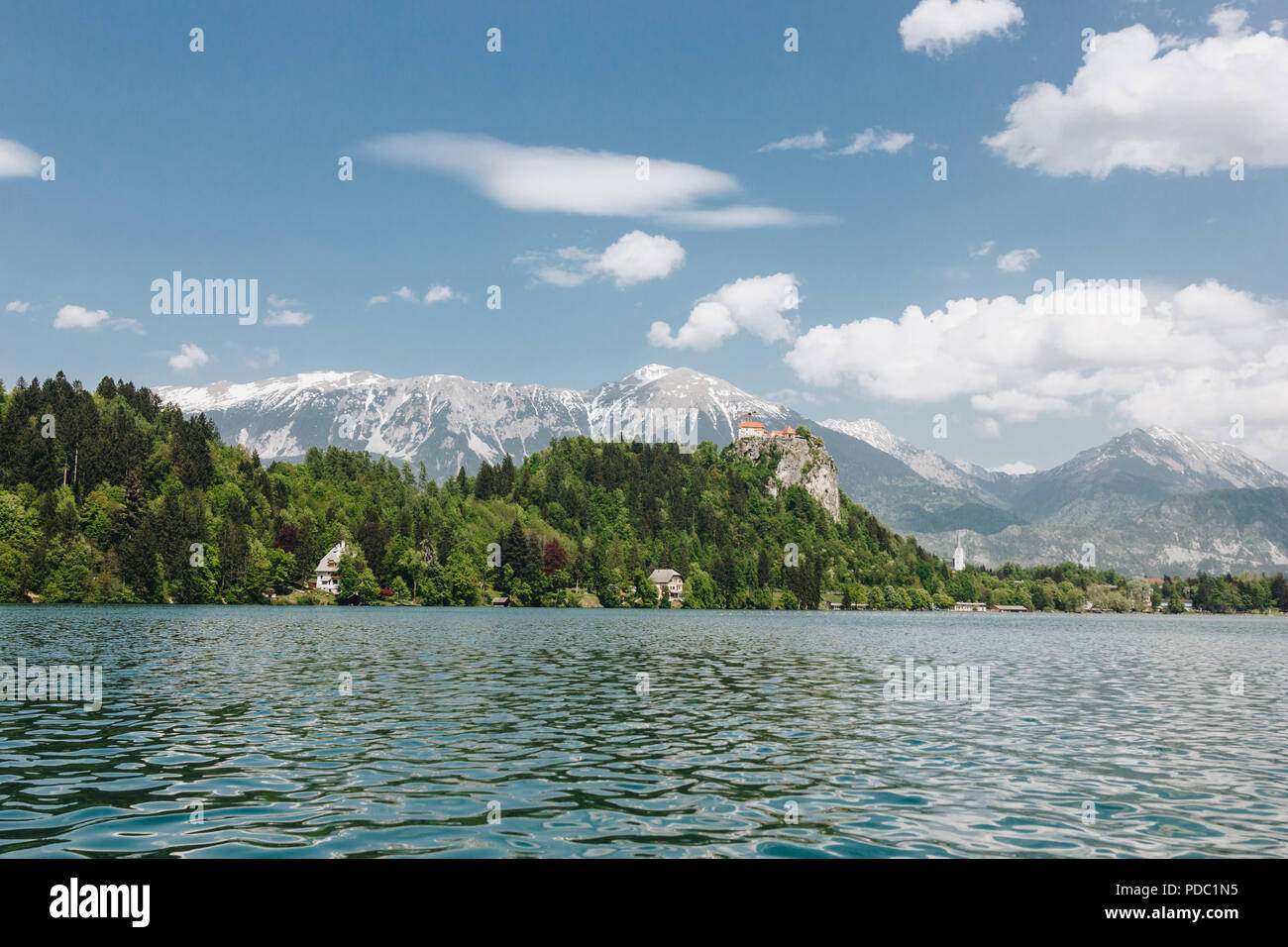 beautiful landscape with snow-covered mountain peaks, green vegetation ...
