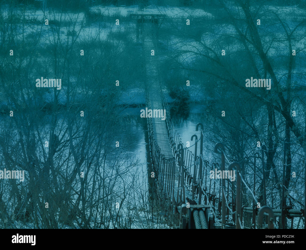 Creepy old suspension bridge across the river in the fog. Theme for ...