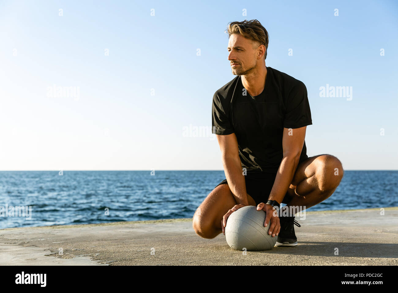 Man fit ball sitting hi-res stock photography and images - Alamy