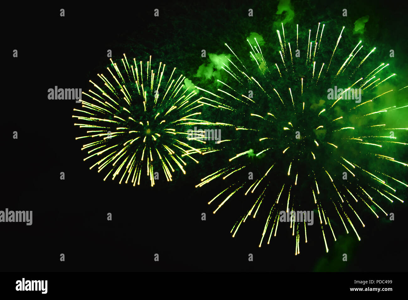 Brightly green color fireworks on dark background, shaped in the ...