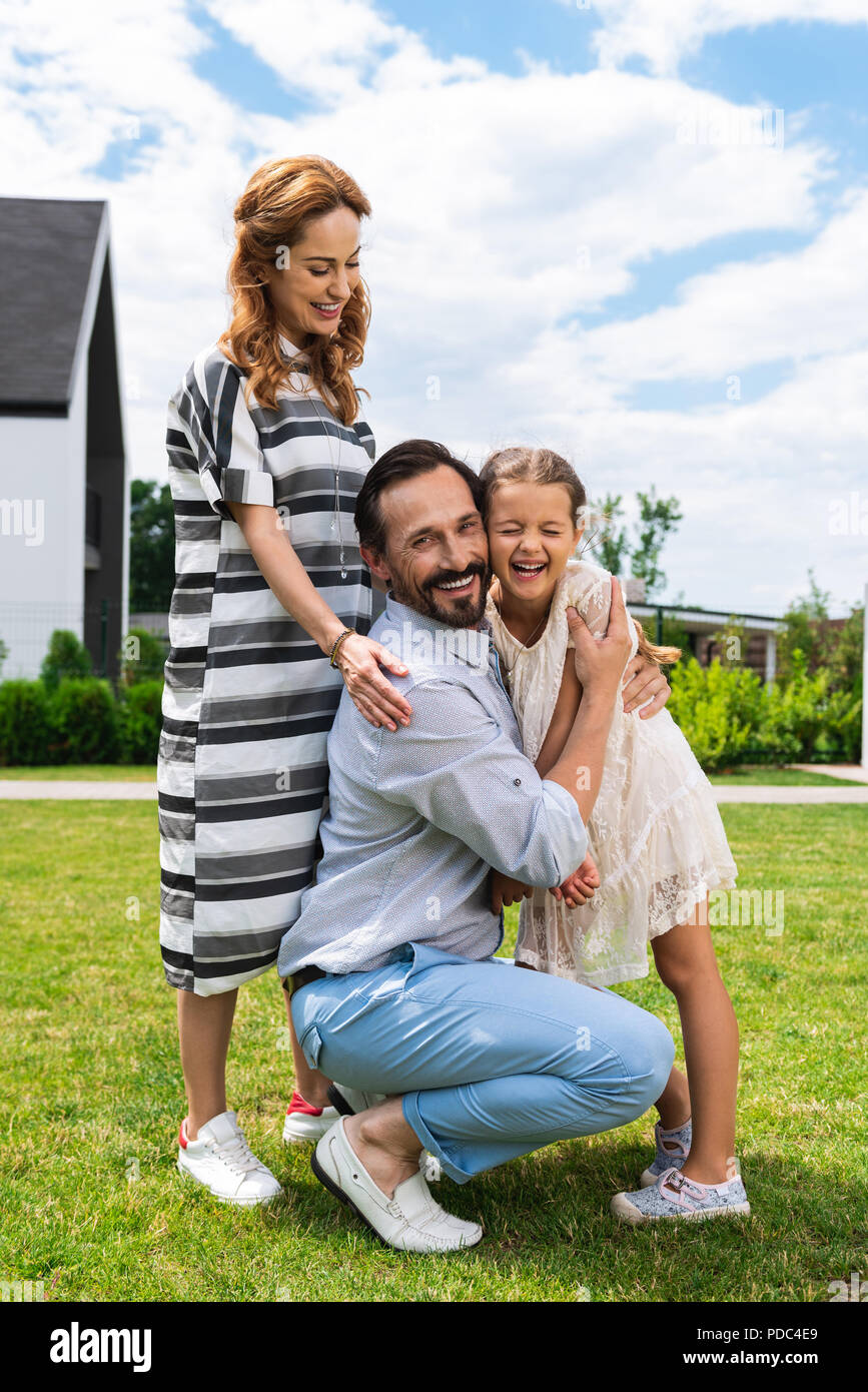 Nice handsome man hugging his daughter Stock Photo - Alamy