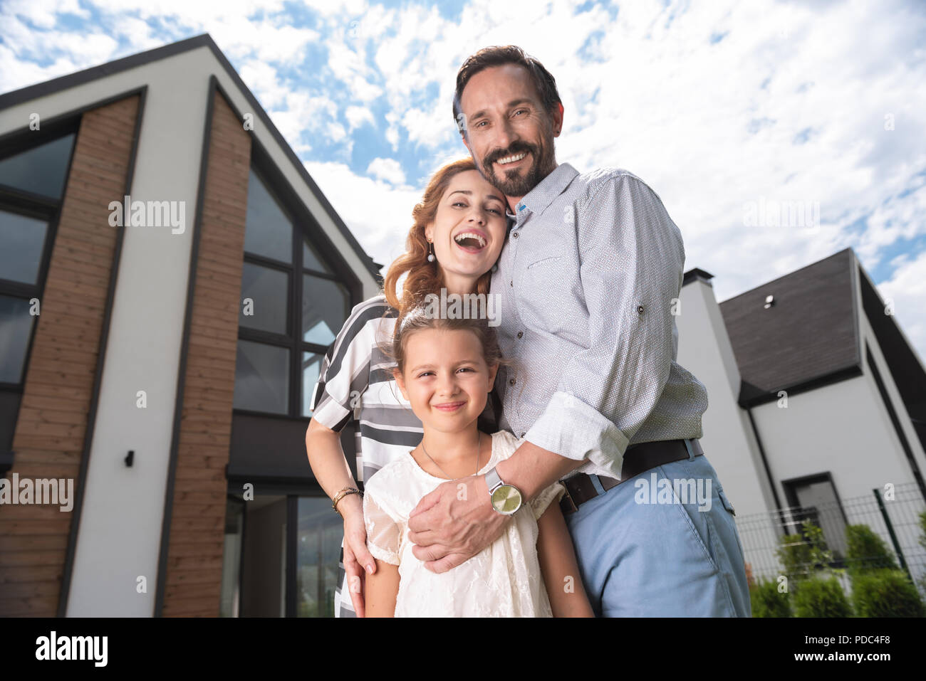 Joyful nice family looking at you Stock Photo - Alamy