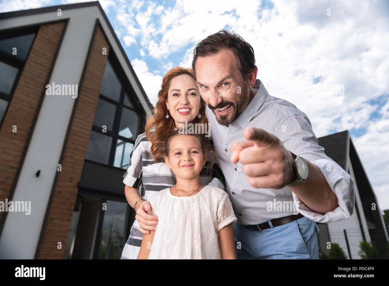 Family pointing house sky hi-res stock photography and images - Alamy
