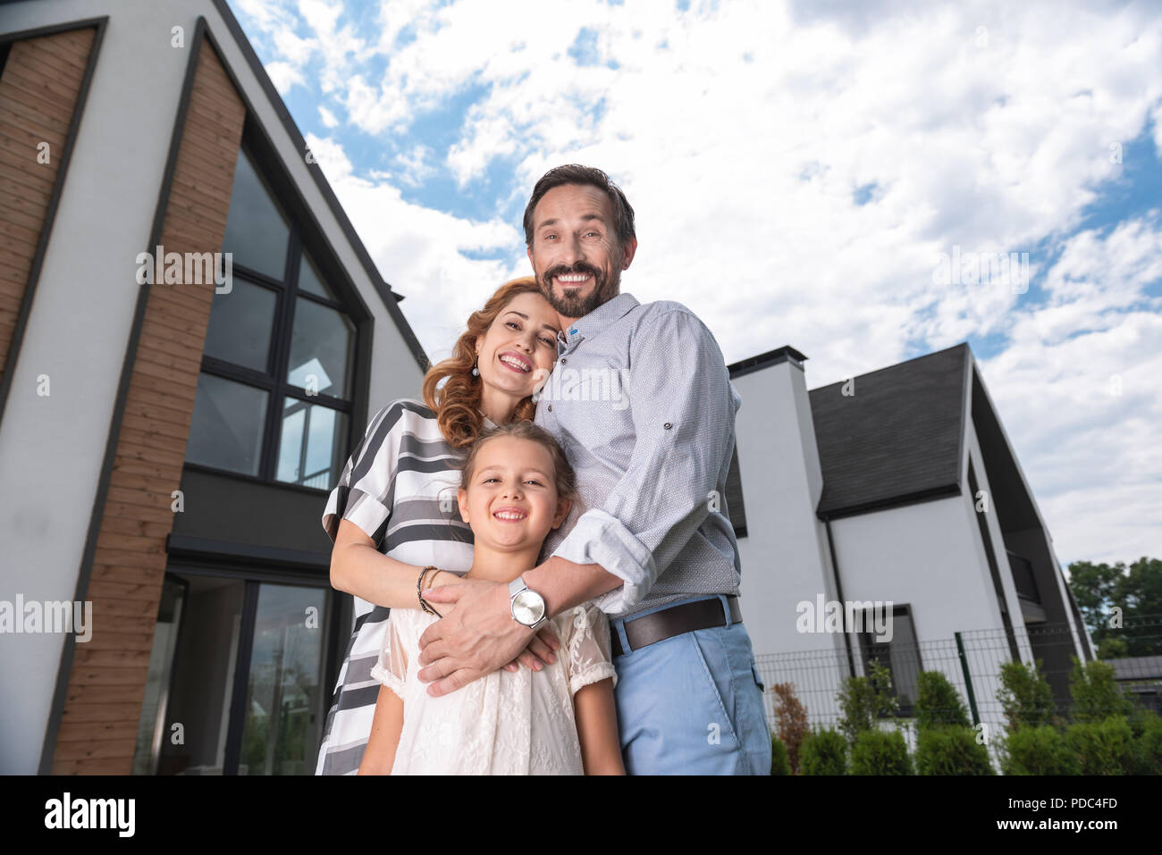 Happy cheerful family hugging each other Stock Photo - Alamy