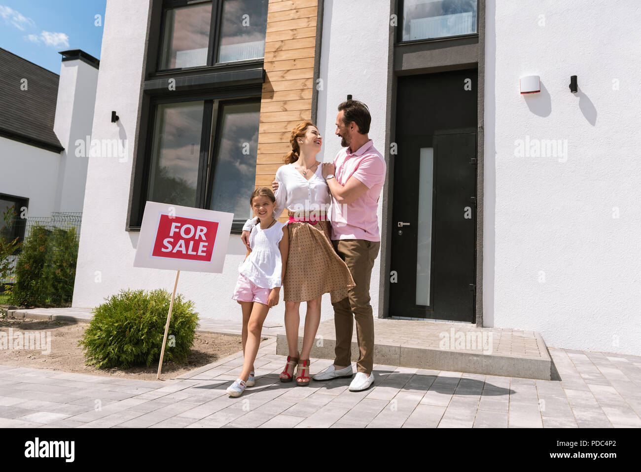 Happy delighted family making a big purchase Stock Photo - Alamy