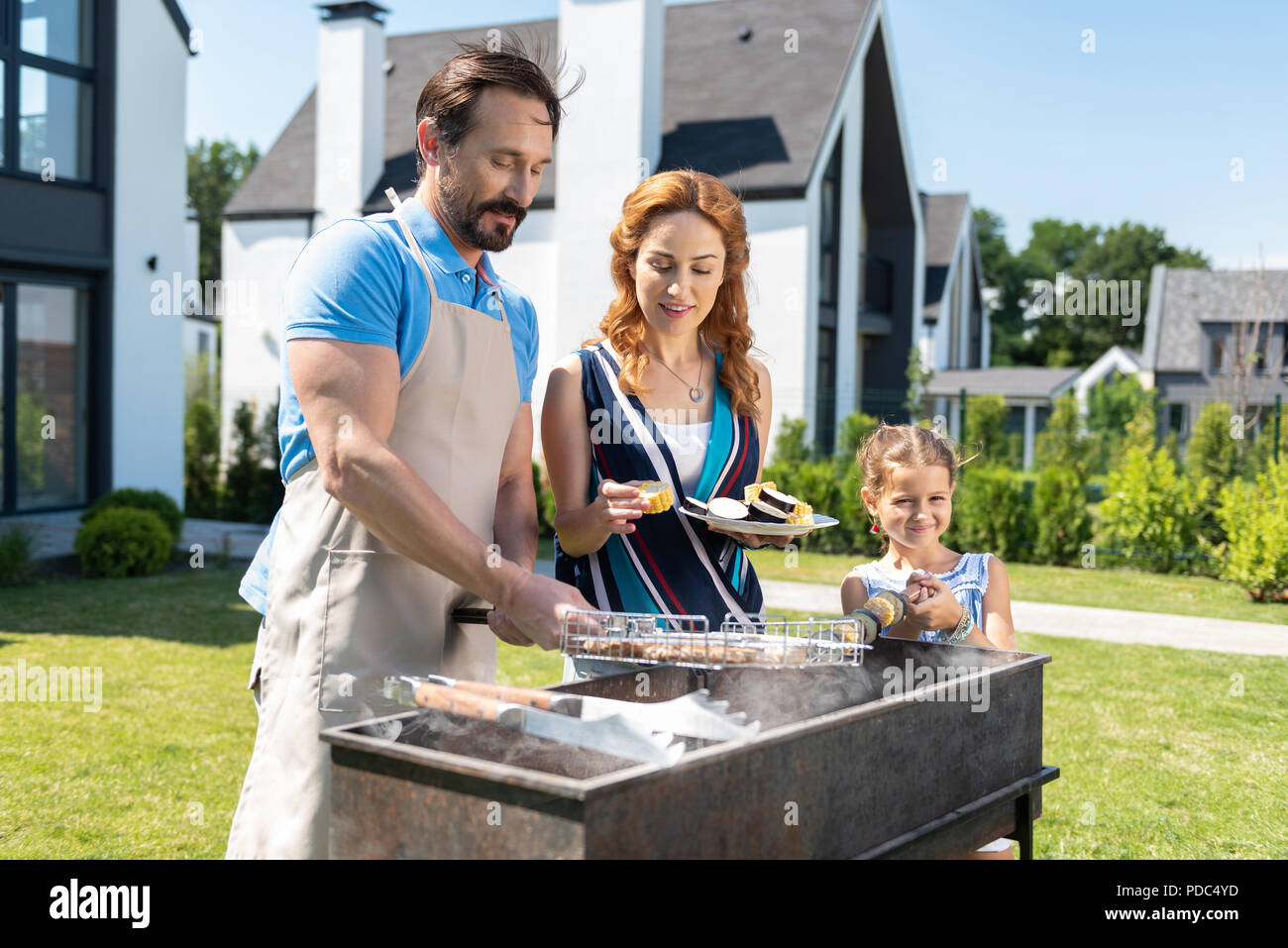 Smart nice man preparing barbeque Stock Photo - Alamy