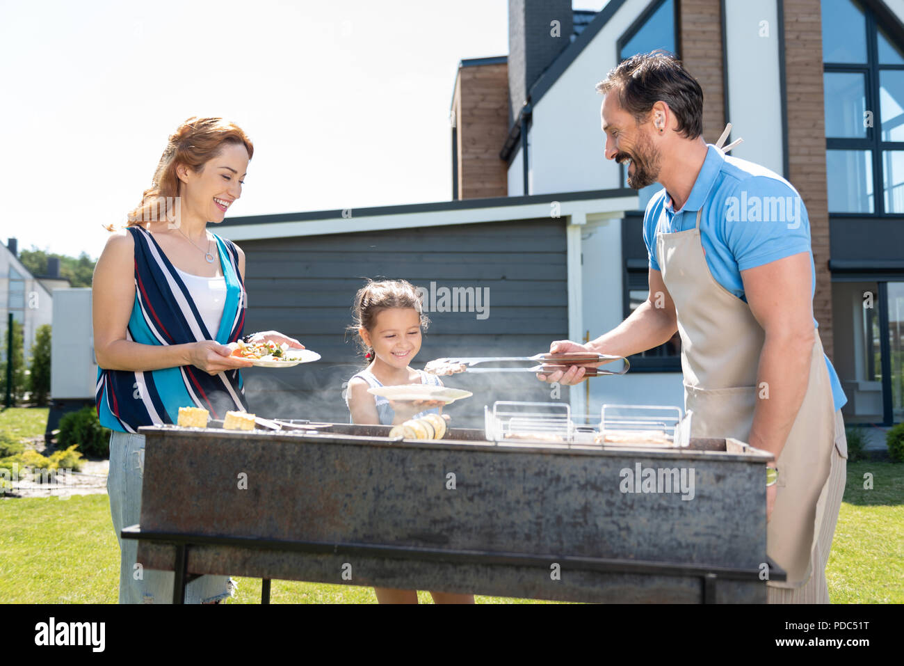 Woman serving delicious grilled hi-res stock photography and images - Alamy