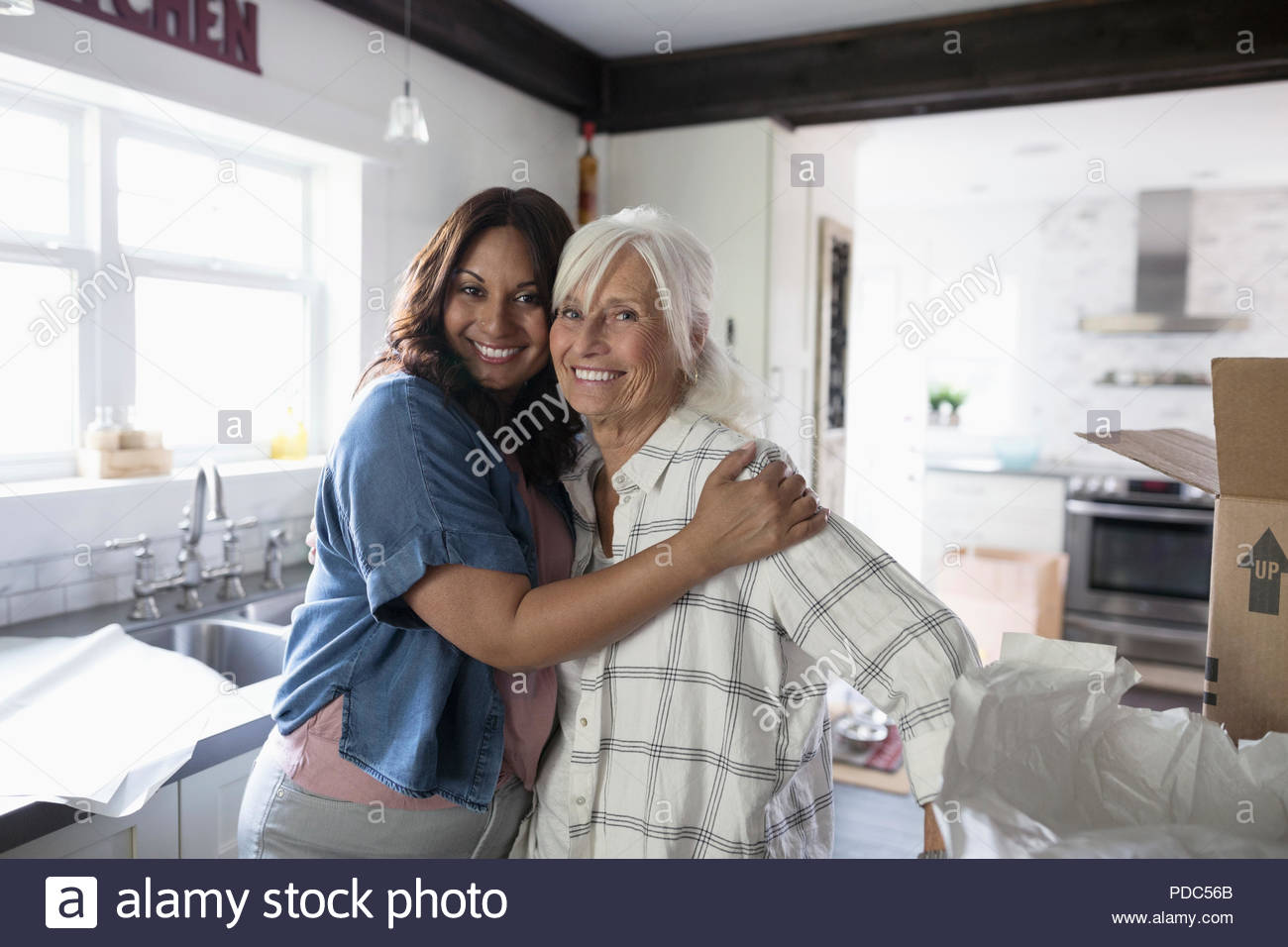 Portrait mother hugging daughter at home hi-res stock photography and images - Alamy