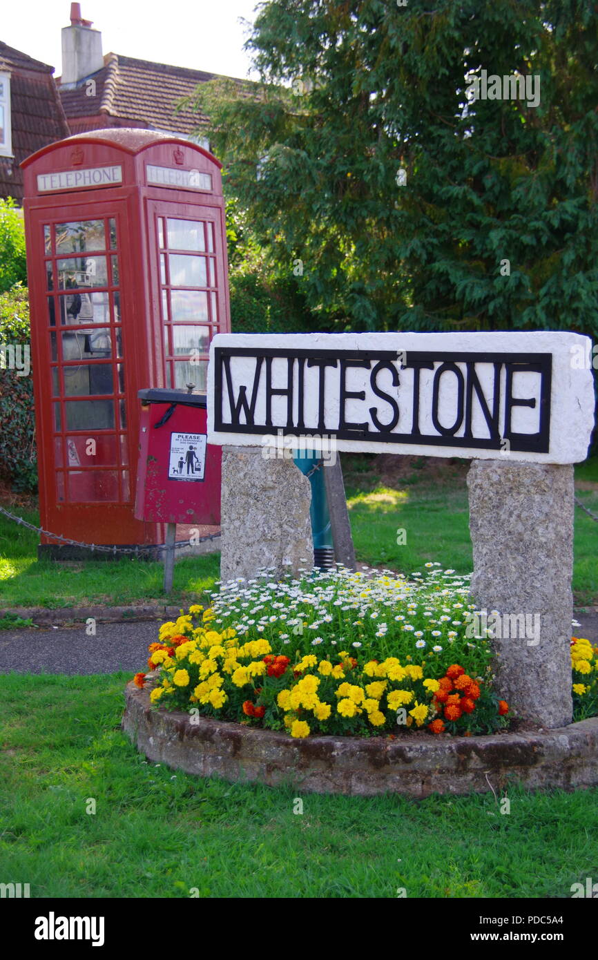Red British Telephone Box by Whitestone Village Name Sign on a Summers ...