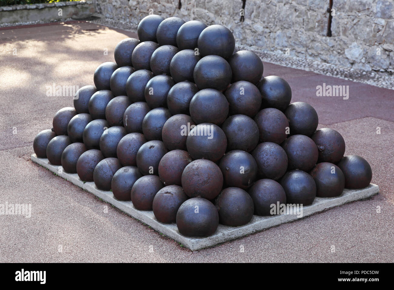Big bunch of solid iron canonballs medieval ammunition Stock Photo - Alamy