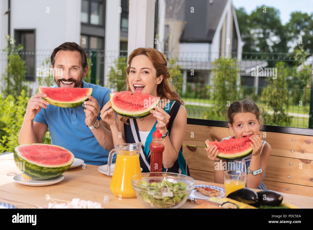 Happy family enjoying meal hi-res stock photography and images - Alamy