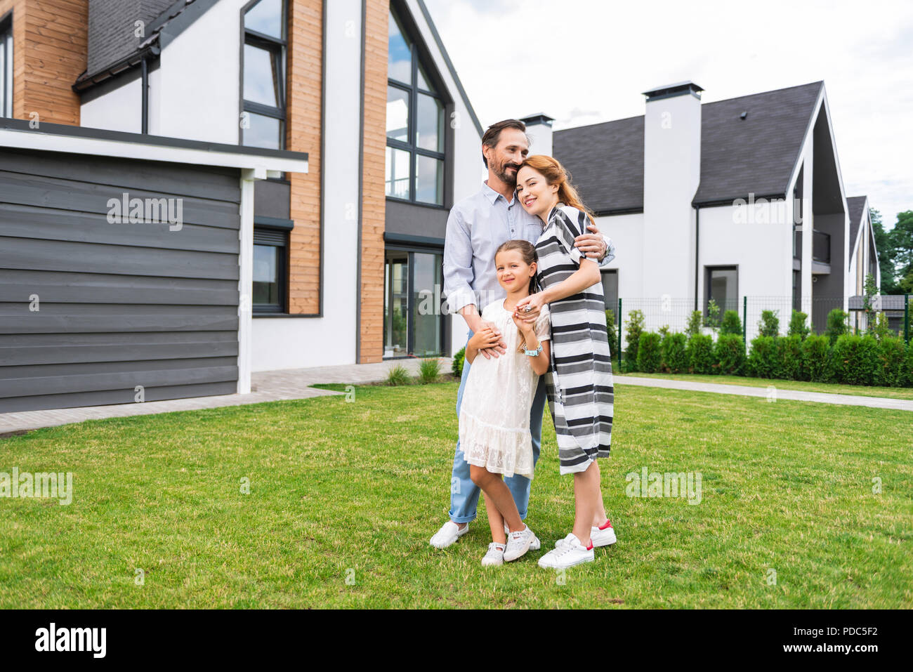 Nice handsome man hugging his family Stock Photo - Alamy