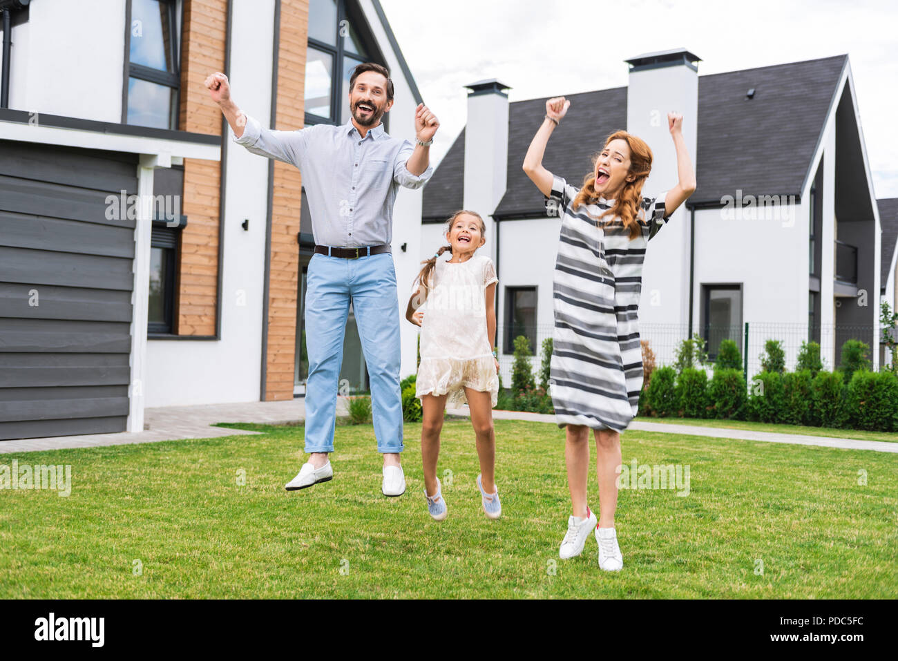 Joyful happy family jumping Stock Photo - Alamy
