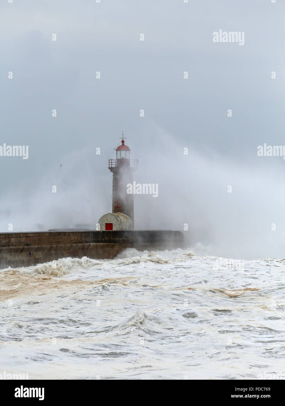 Moody winter seascape with wind spray over lonely lighthouse Stock ...