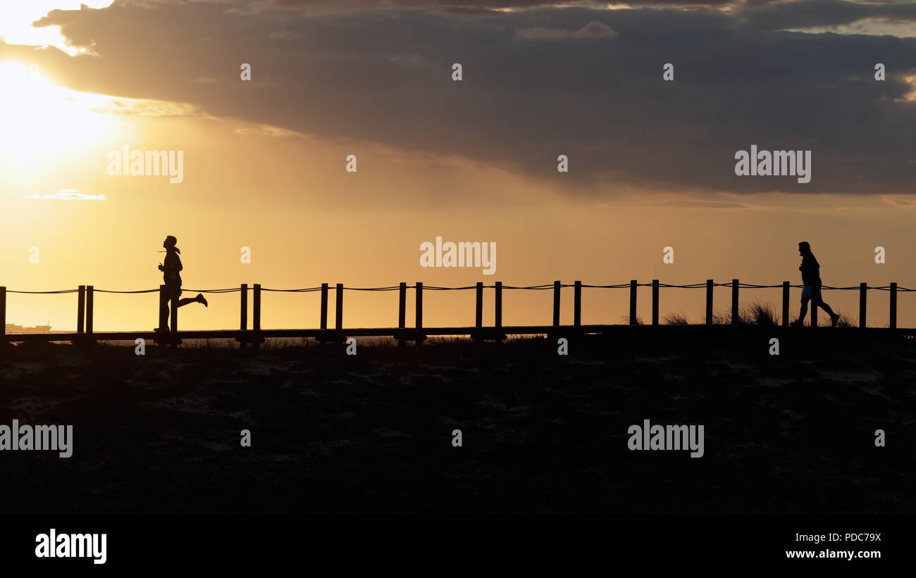 Group running in sunset hi-res stock photography and images - Alamy