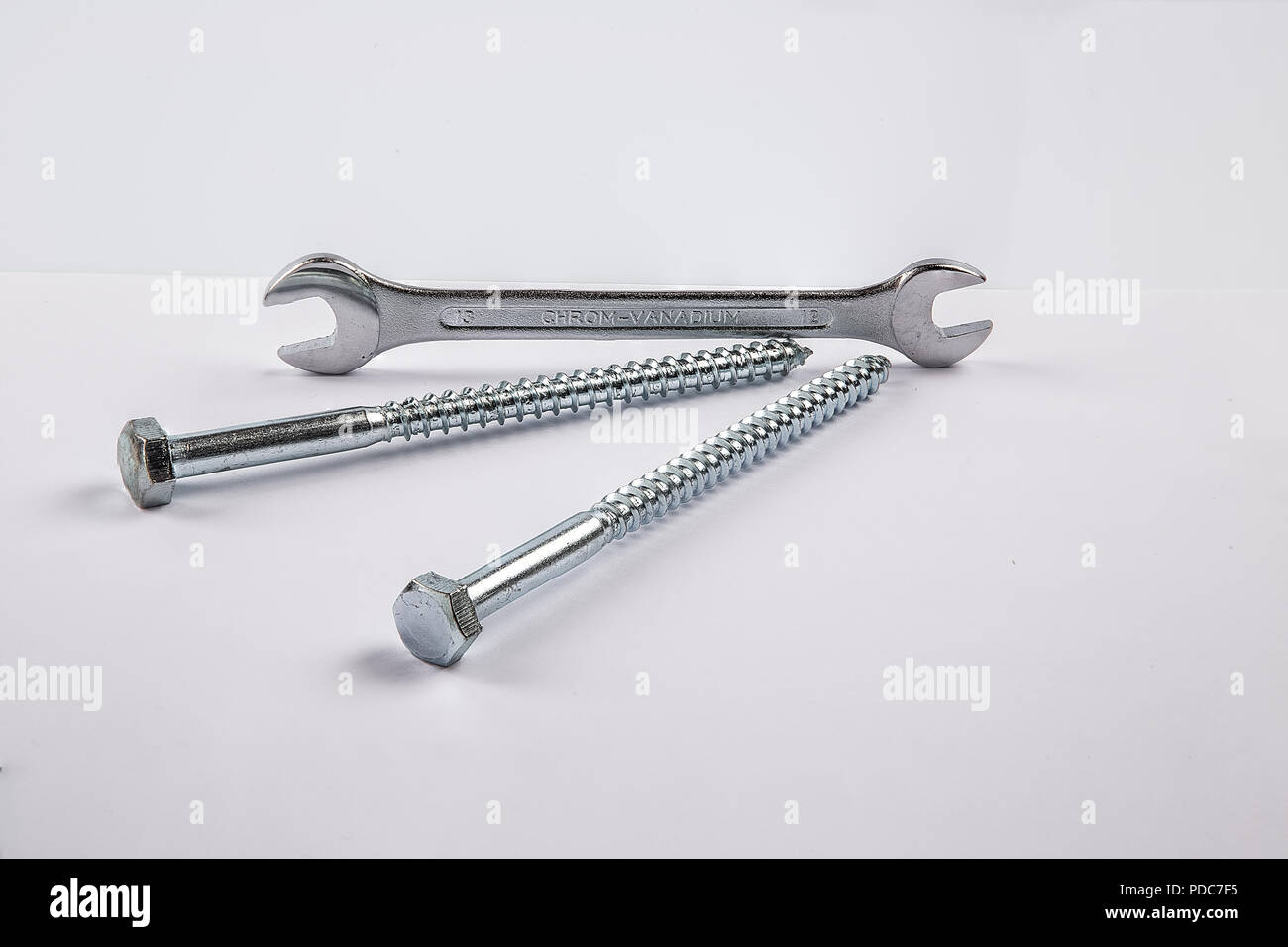 chrom vanadium wrench and steel screws isolated on white background ...