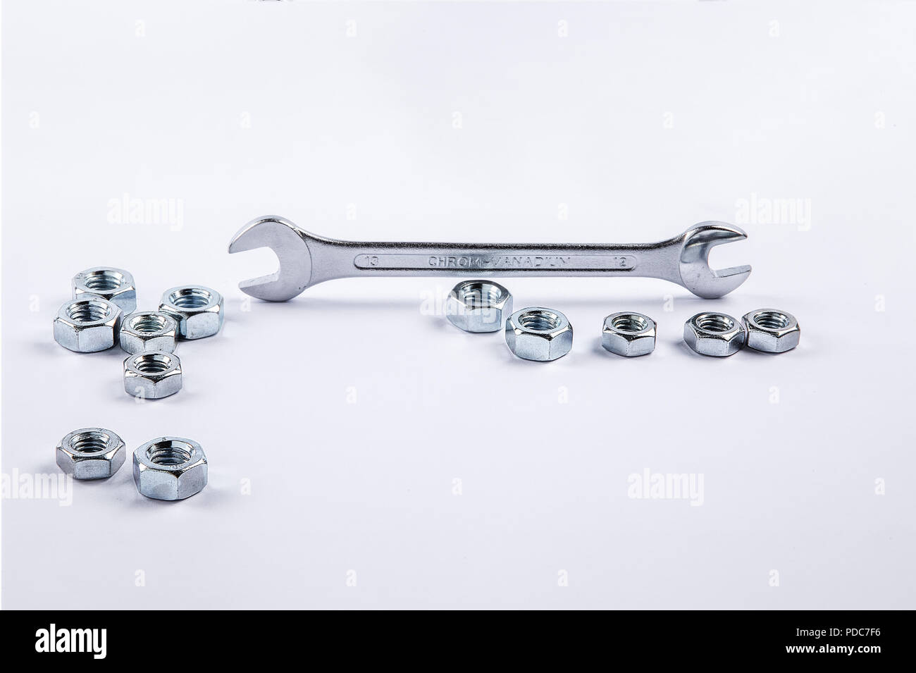 chrom vanadium wrench and steel nuts isolated on white background Stock ...