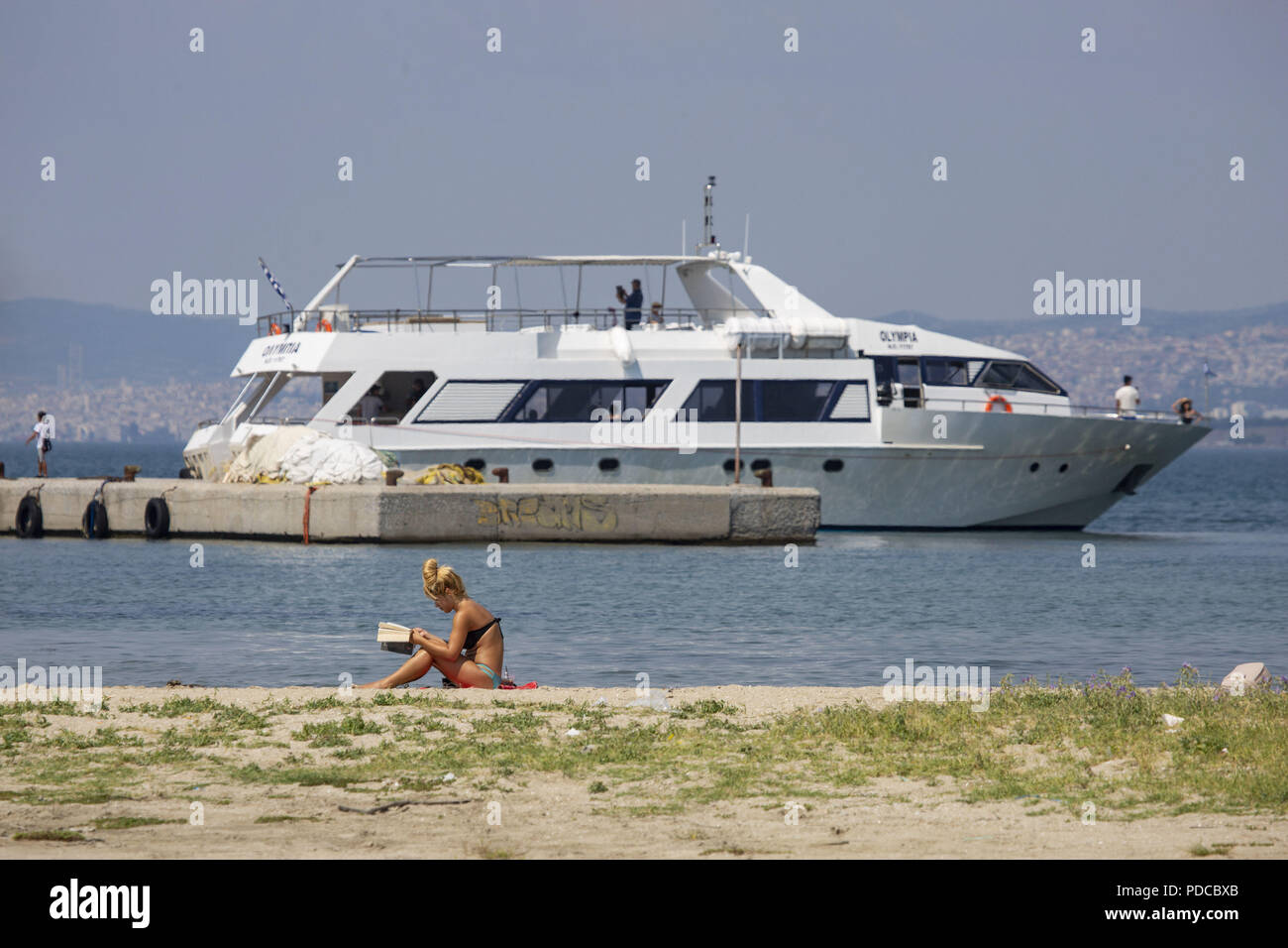 Perea, Thessaloniki, Greece. 7th Aug, 2018. A woman is seen sitting in ...