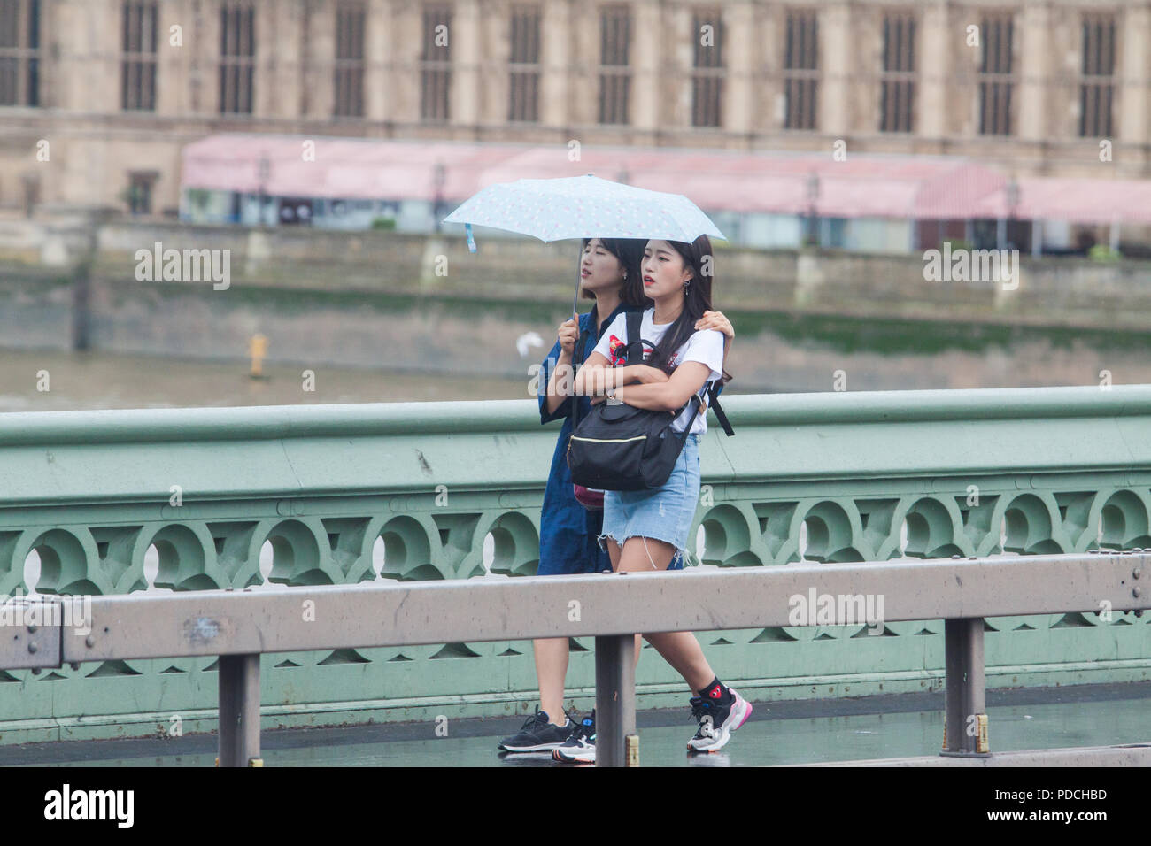 London UK. 9 August 2018. People take out umbrellas on Westminster ...