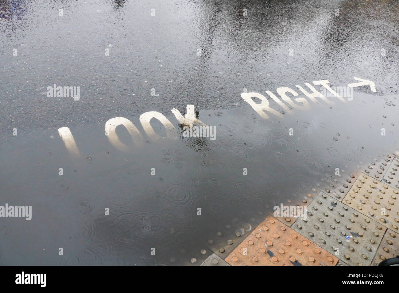London UK. 9th August 2018. Pedestrian crossing covered in water from ...