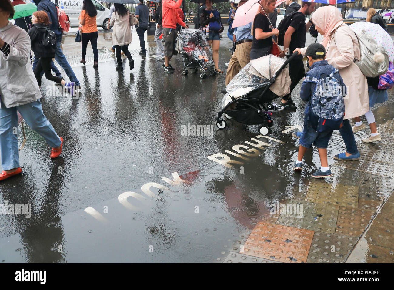 London UK. 9th August 2018. Pedestrian crossing covered in water from ...