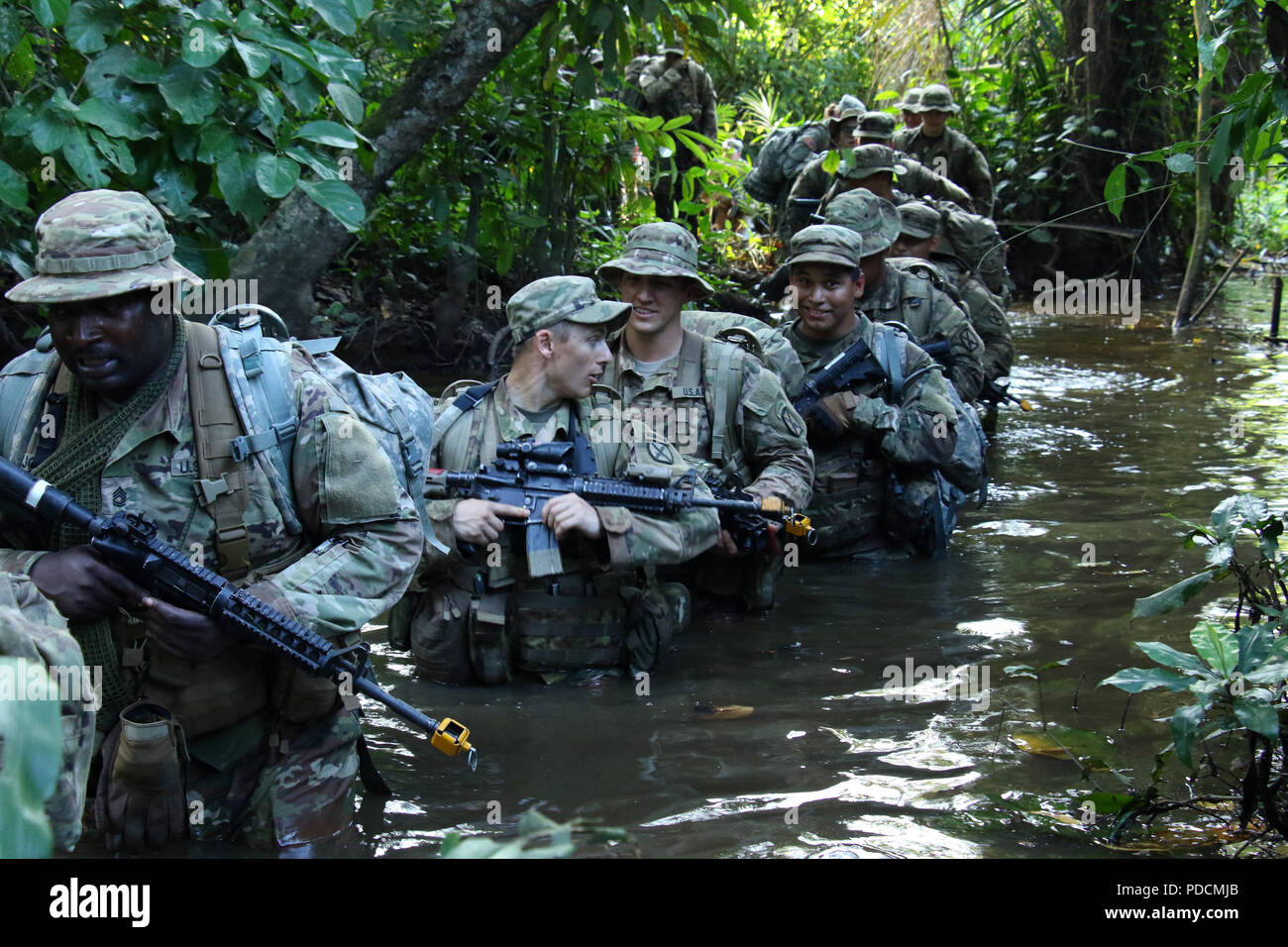 U.S. Army Soldiers wade through the water of the jungle during Jungle ...