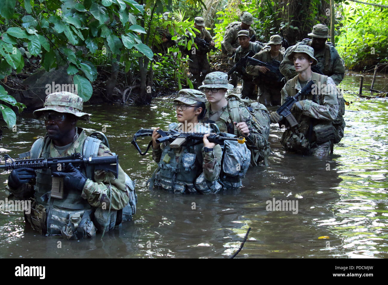U.S. Army Soldiers wade through the water of the jungle during Jungle ...