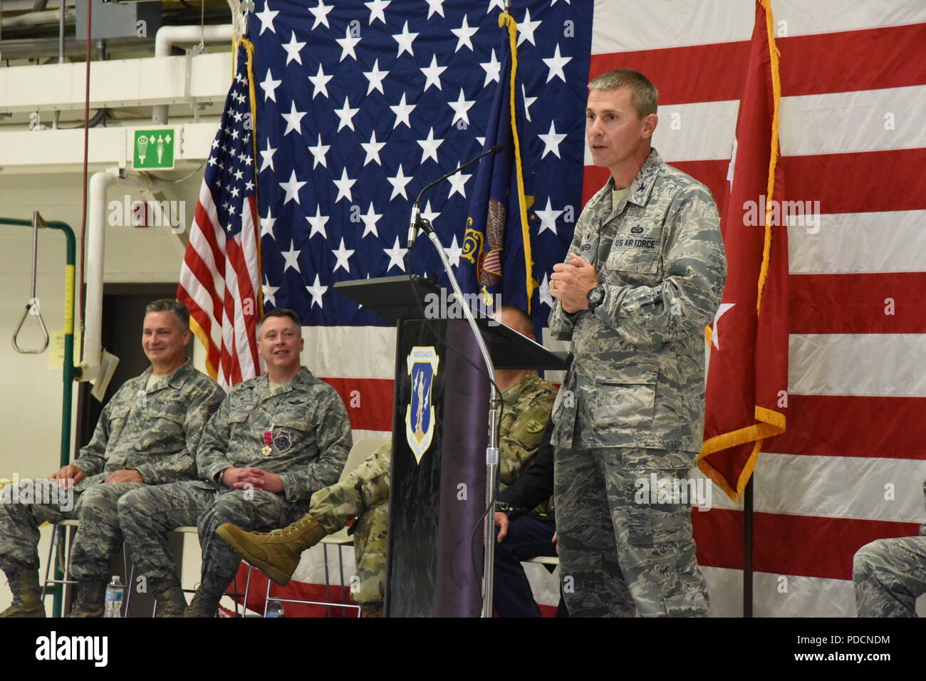 Col. Darrin Anderson addresses the 119th Wing unit members standing in ...