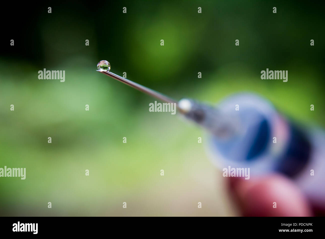 Syringe with needle on blur background Stock Photo - Alamy